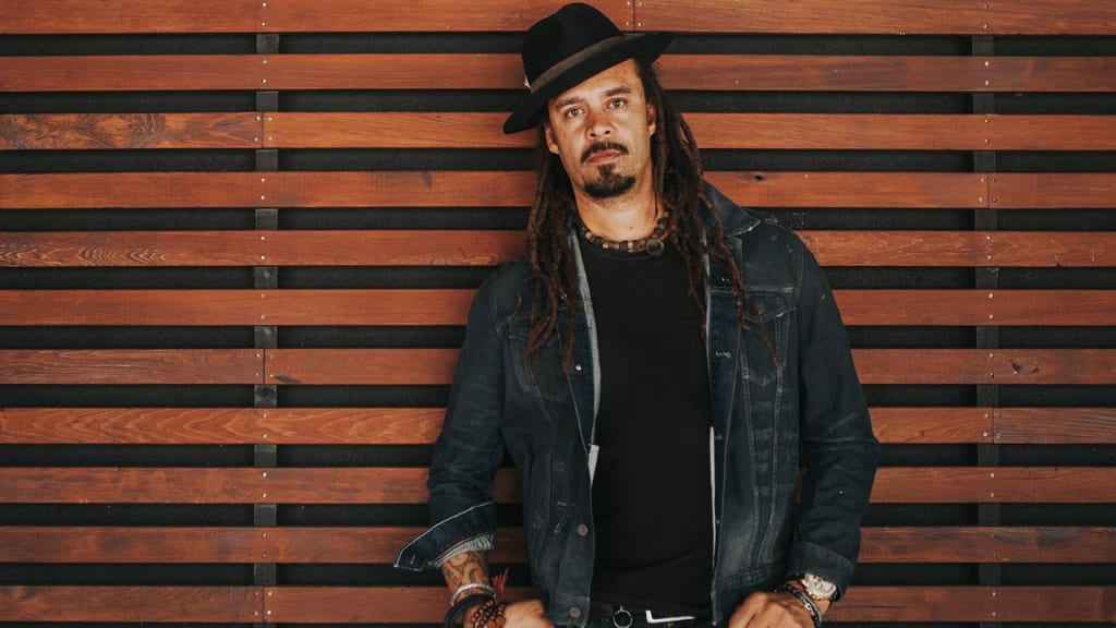 Michael Franti performing at Soul Pose MLB
