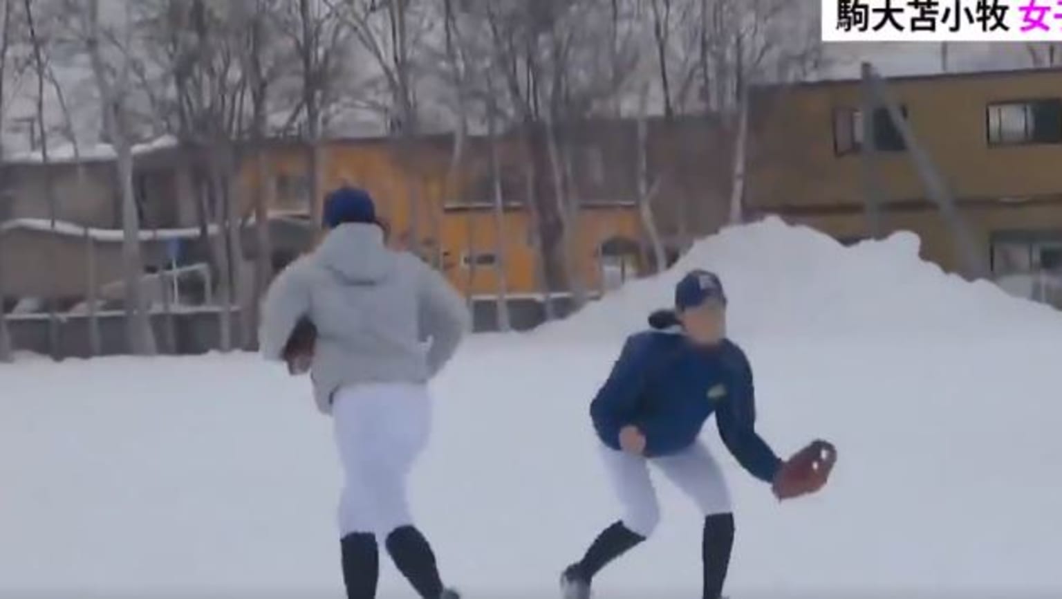 Girls baseball team plays in snow