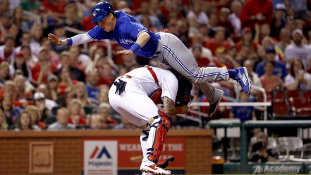 Chris Coghlan jumps over Yadier Molina anniversary