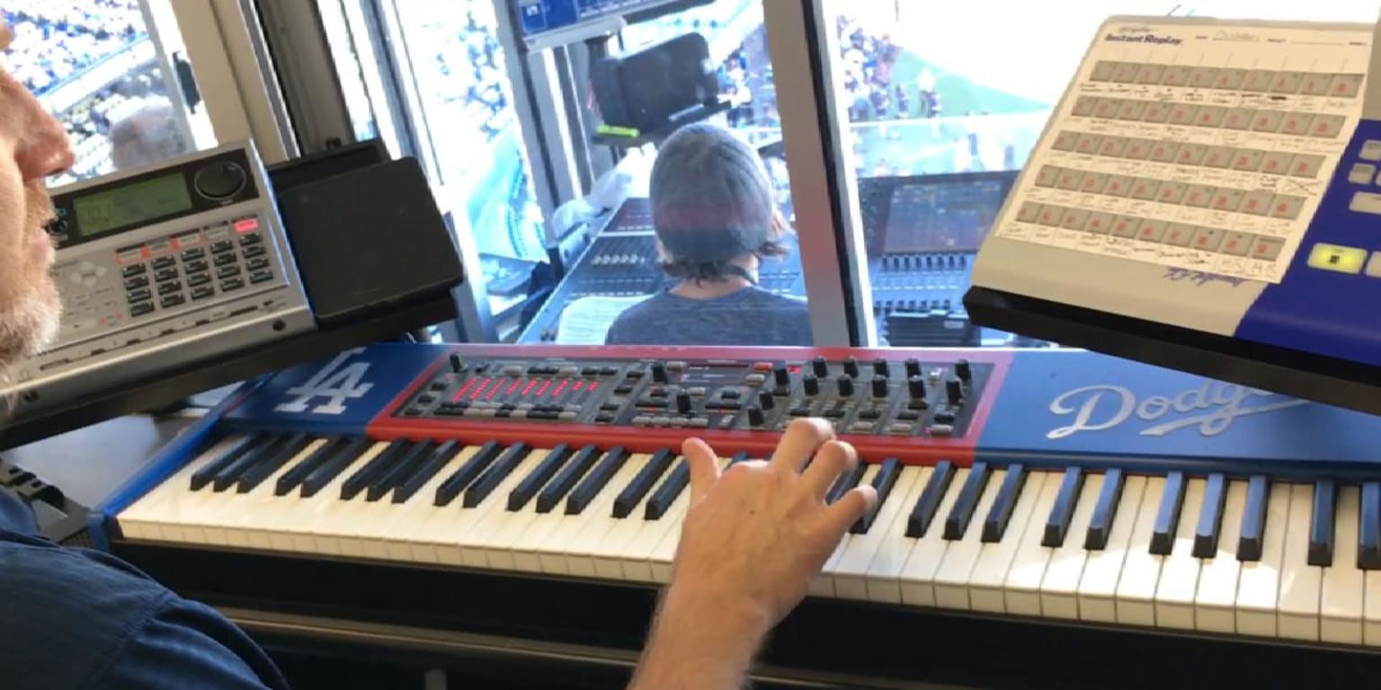 Sharing tricks of the trade with Dodgers organist Dieter Ruehle, during ...