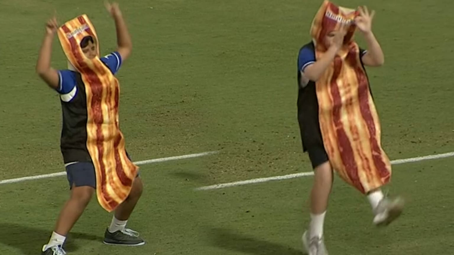 Fans compete in a dance contest in bacon costumes | 08/23/2023 | MLB.com