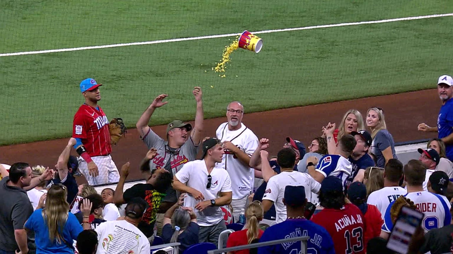A fan tosses up a popcorn bucket to knock down a ball | 09/16/2023 ...