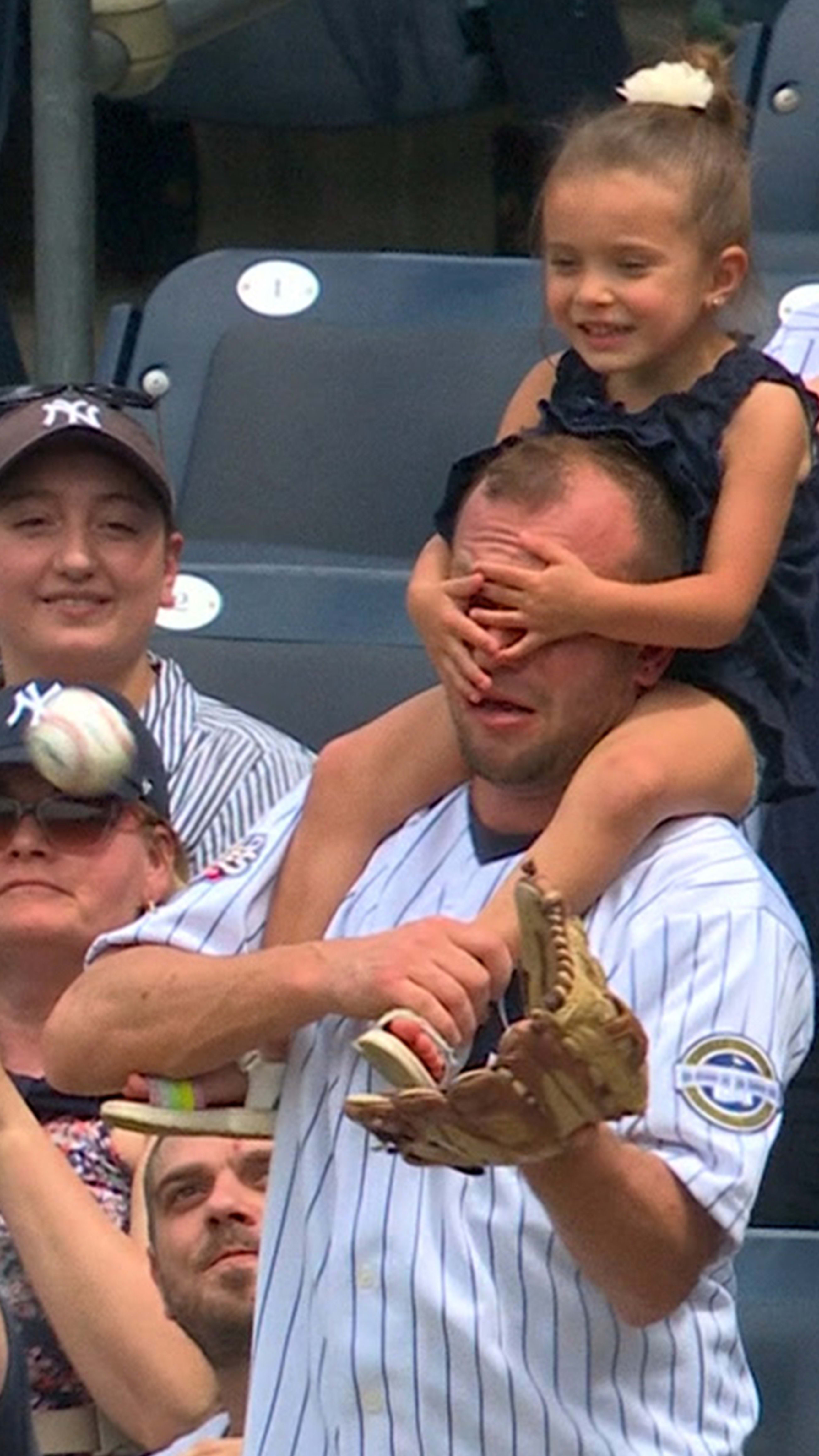 man catching baseball
