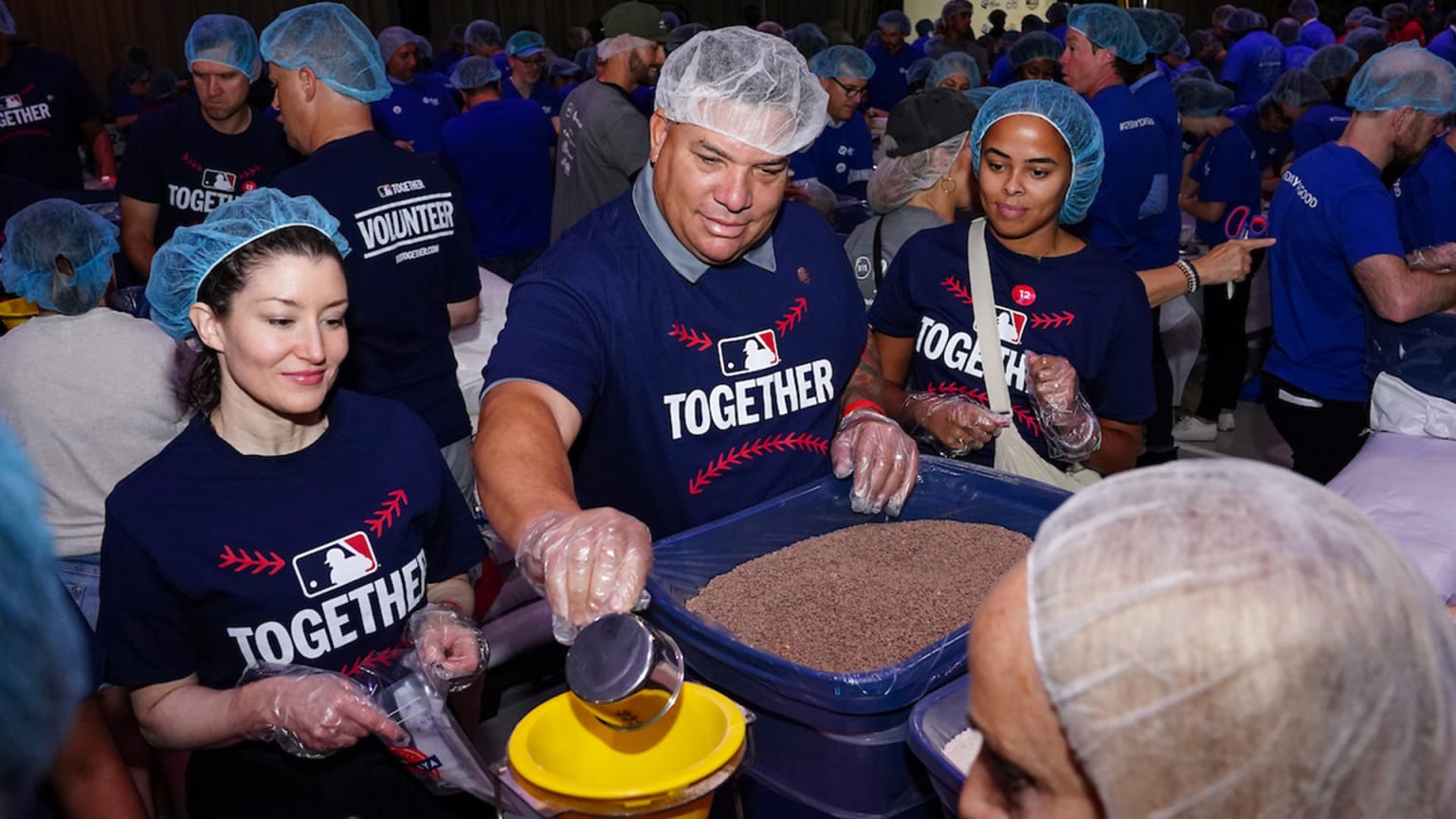 MLB Together volunteers pack meals for families in need