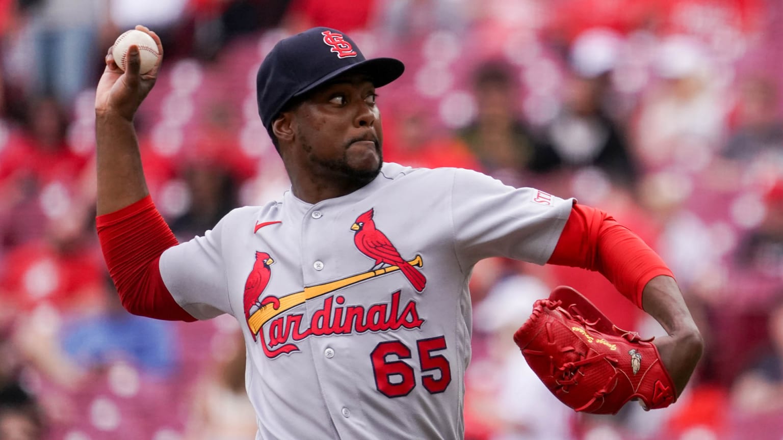 Cardinals wearing navy caps on road in 2026