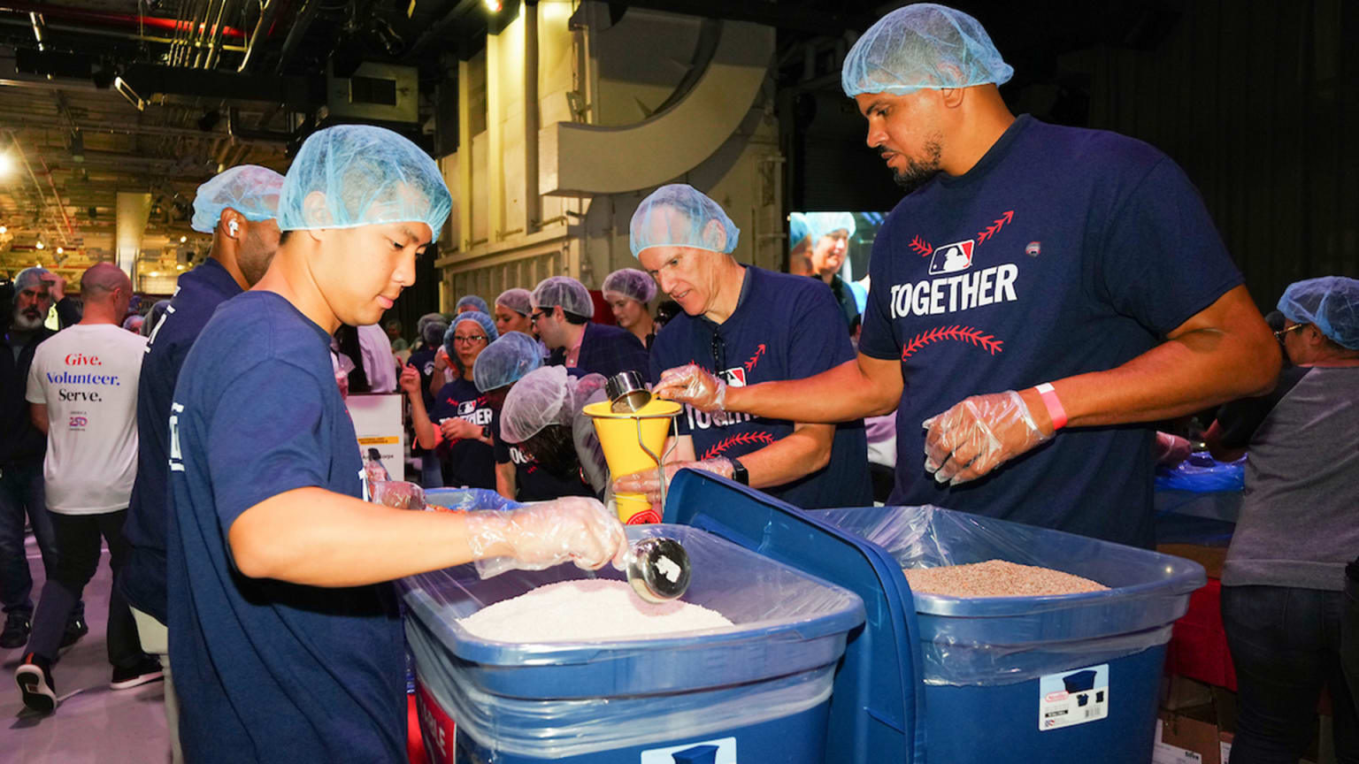 MLB Together volunteers pack meals for families in need