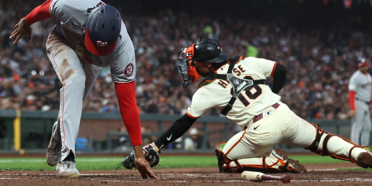 James Wood scores by reaching down to touch home plate